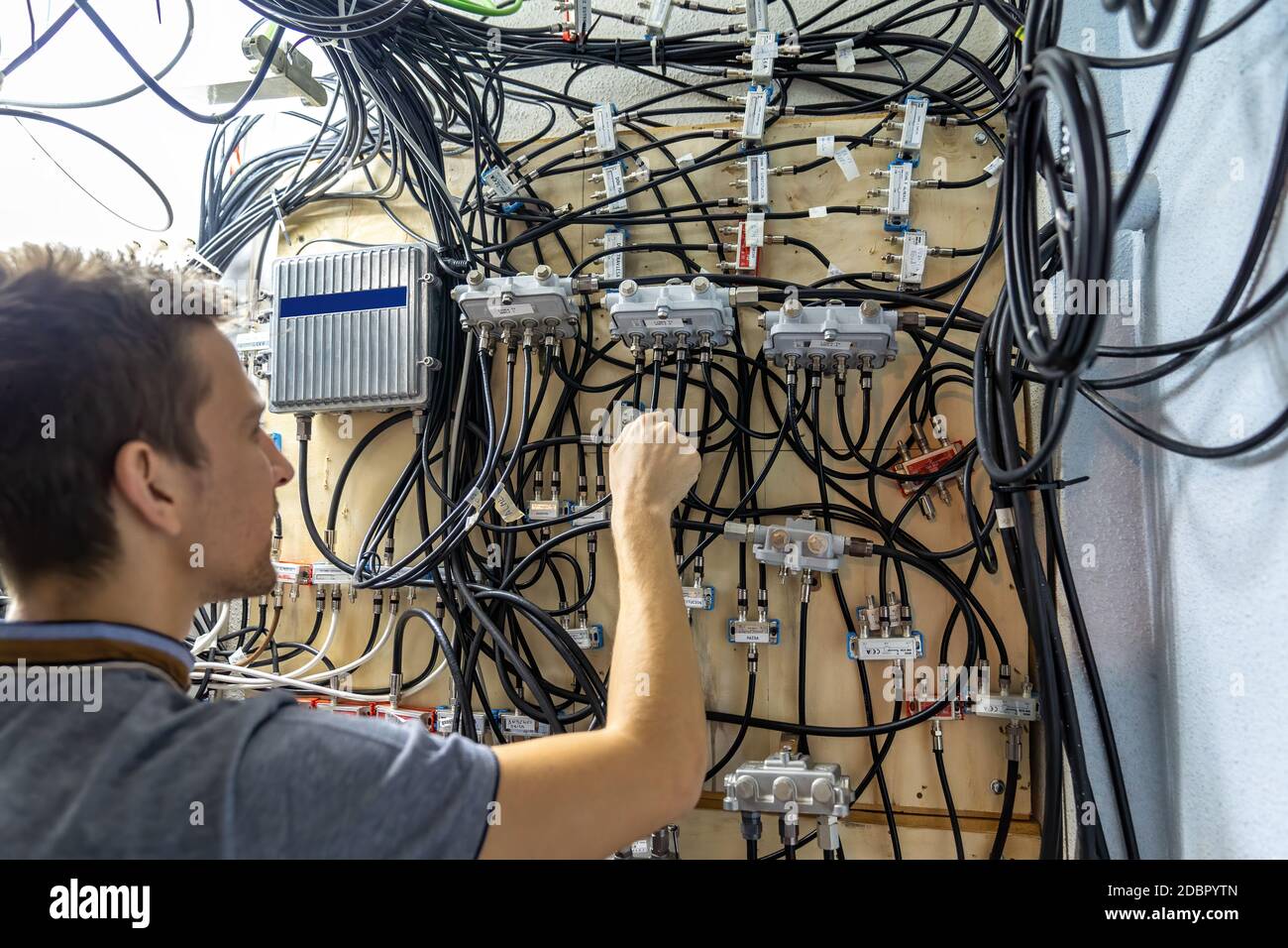 Technician engineer fixing problem with servers and data in cables room ...