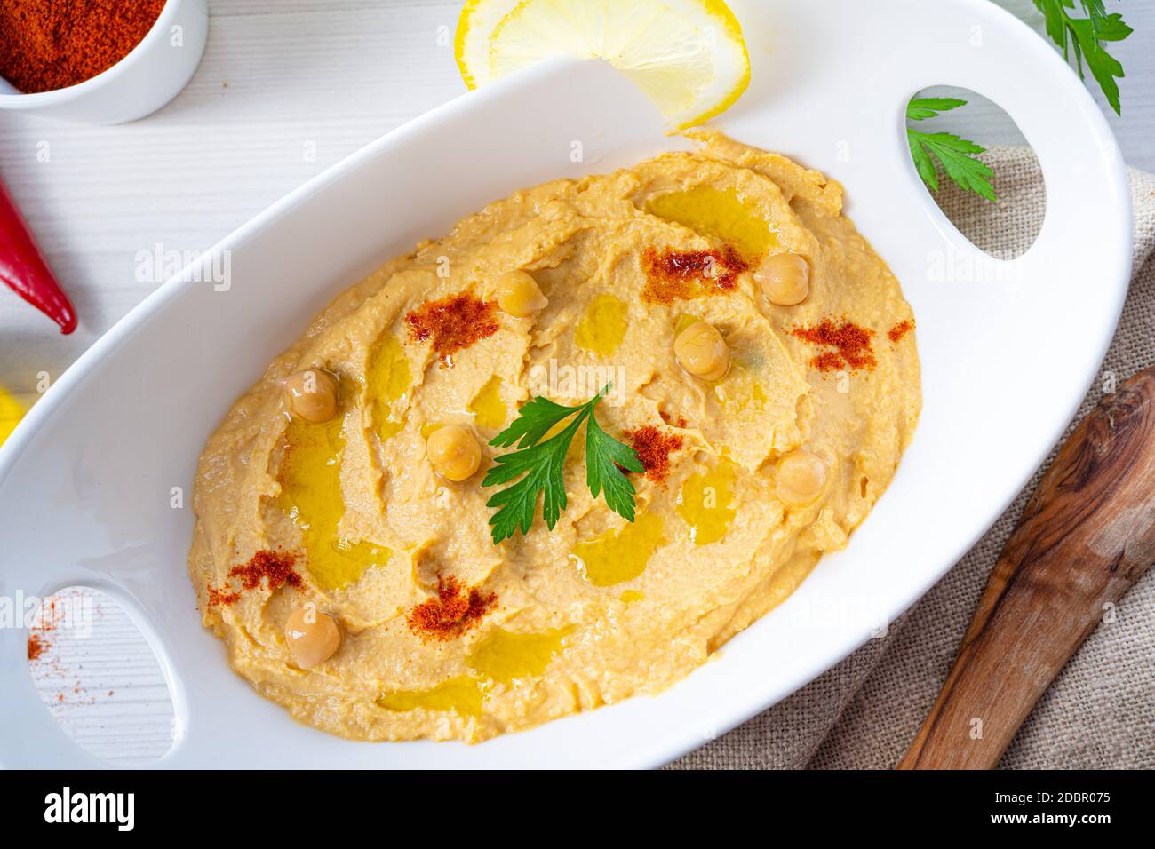 hummus paste with lemon and chilli on white background Stock Photo - Alamy