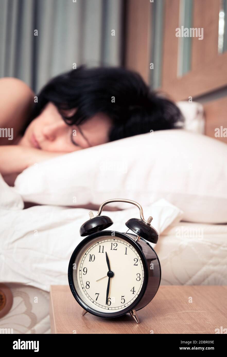 Alarm clock and the woman Stock Photo - Alamy
