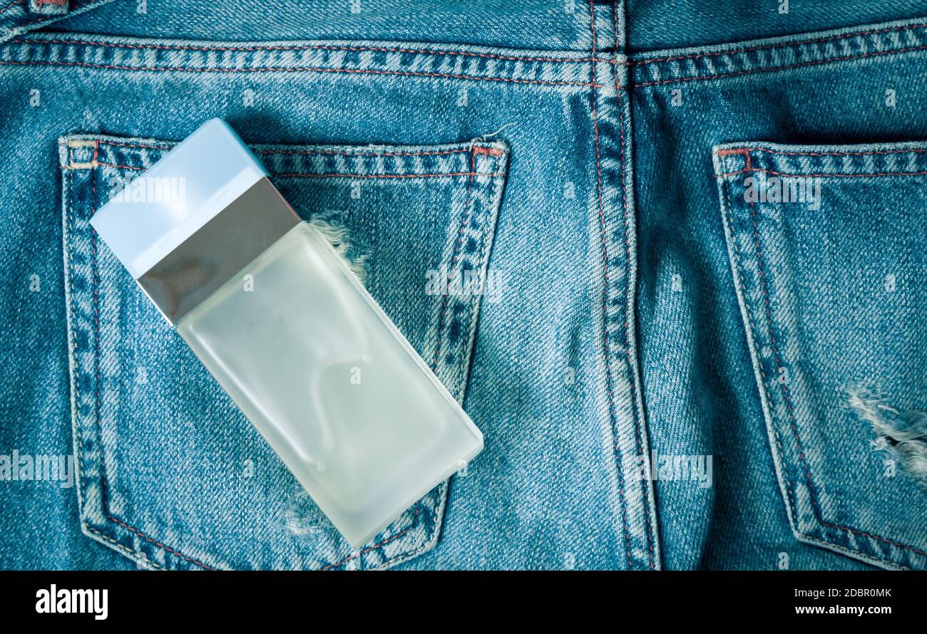 Bottle of perfume on the jeans Stock Photo - Alamy