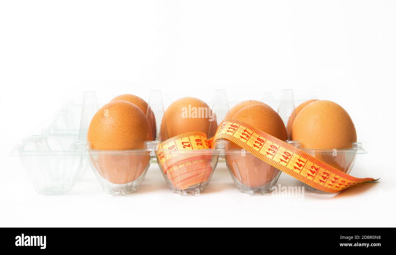 Eggs with the diet meter on the white Stock Photo - Alamy