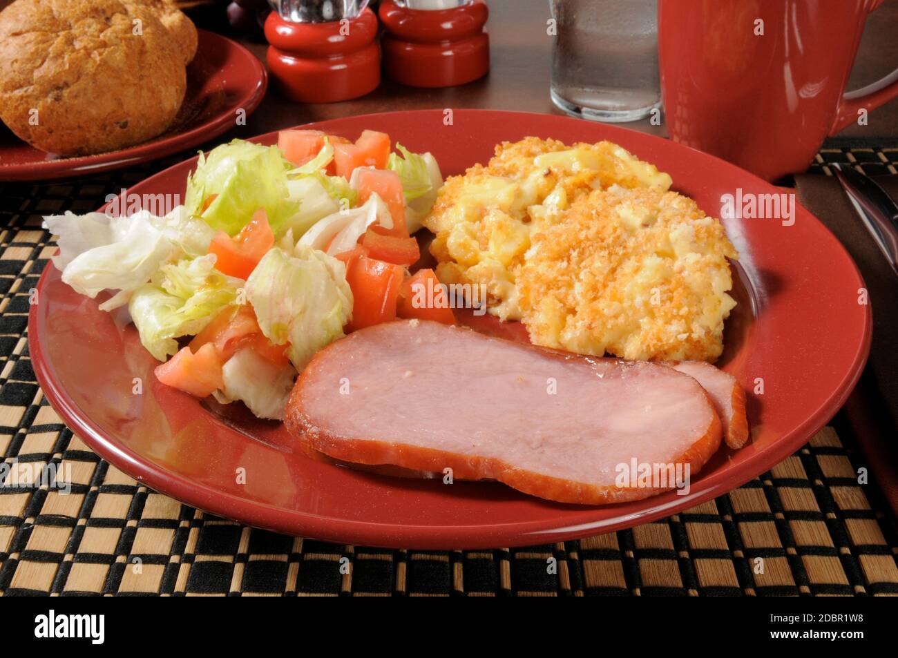 Ham dinner with potatoes baked in cheese Stock Photo - Alamy