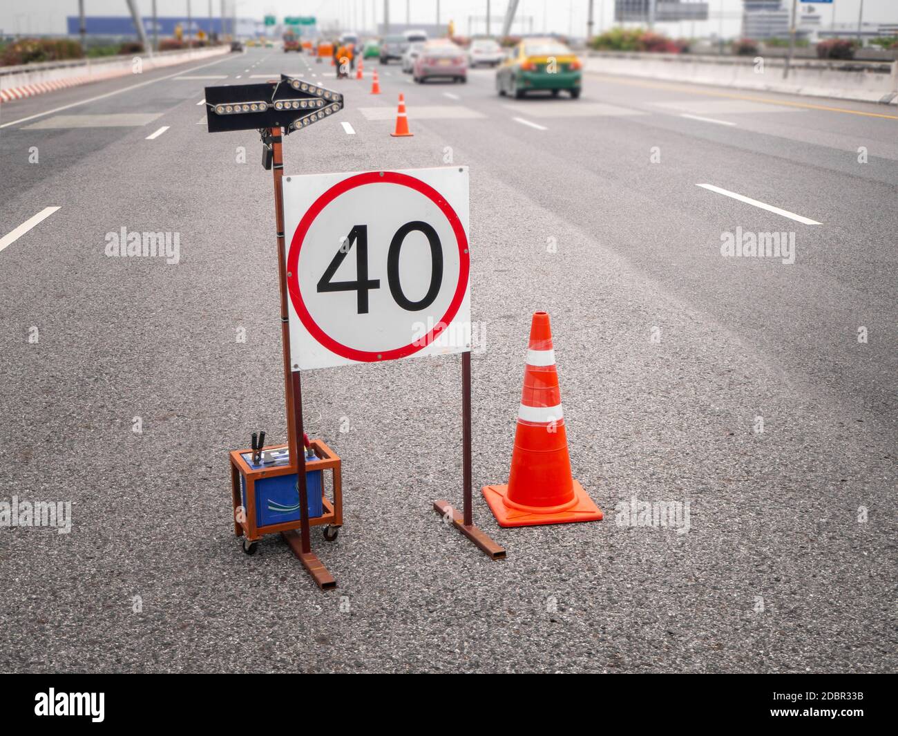 The signs repairs road and worker on the road Stock Photo - Alamy