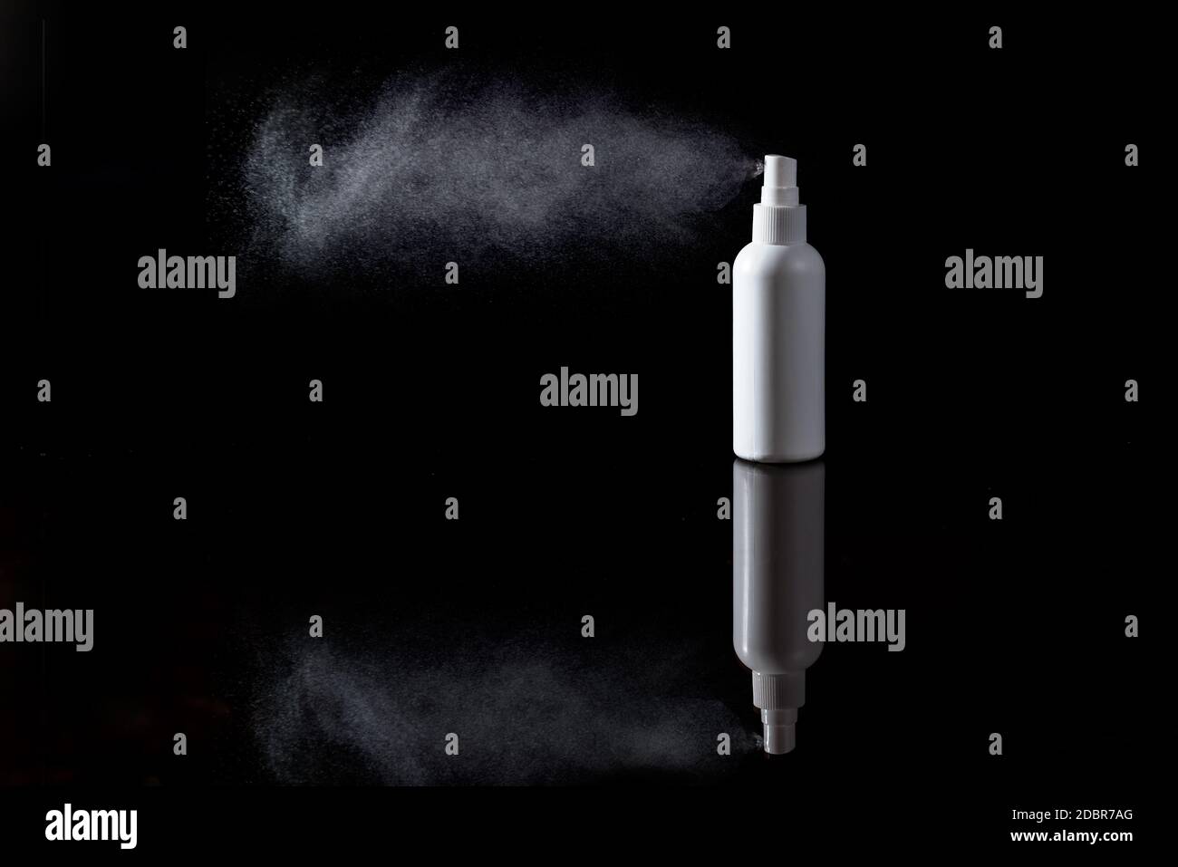 Disinfectant spray plastic bottle on a reflective glass spraying ...