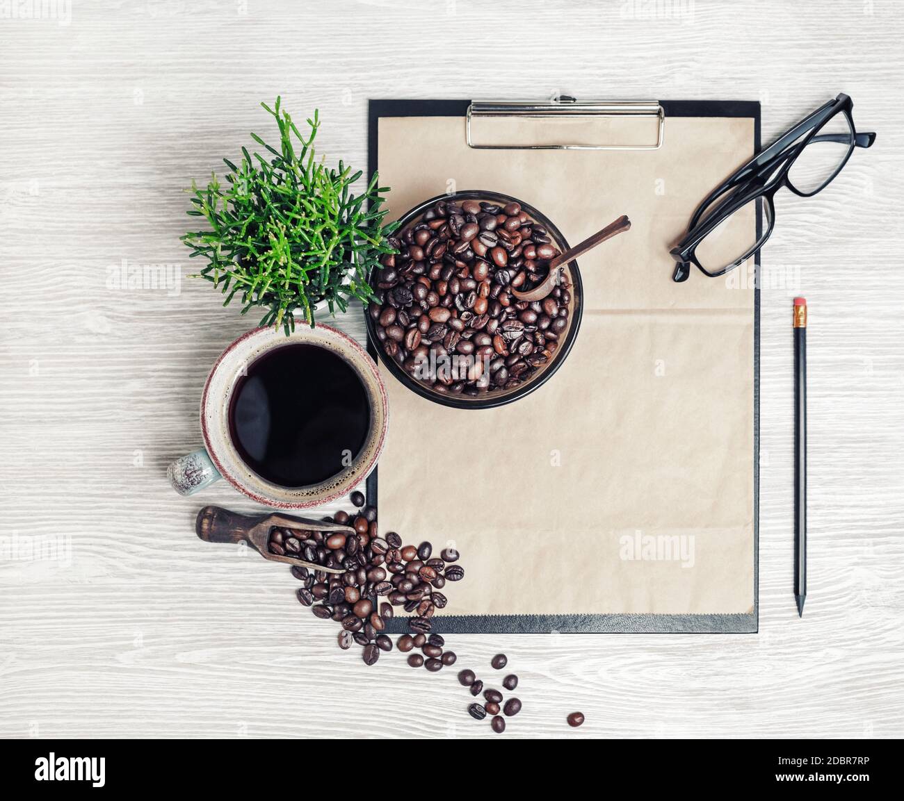 Clipboard with blank kraft letterhead, coffee cup, coffee beans, pencil ...