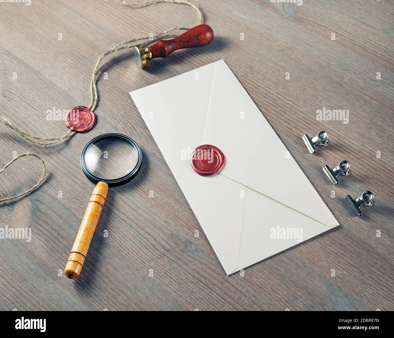 Vintage letter envelope with red wax seal, stamp and magnifier on wood ...