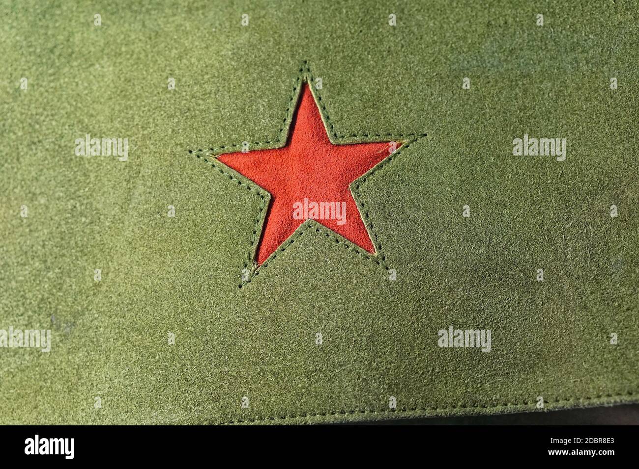 Red star symbol at green textile Stock Photo - Alamy