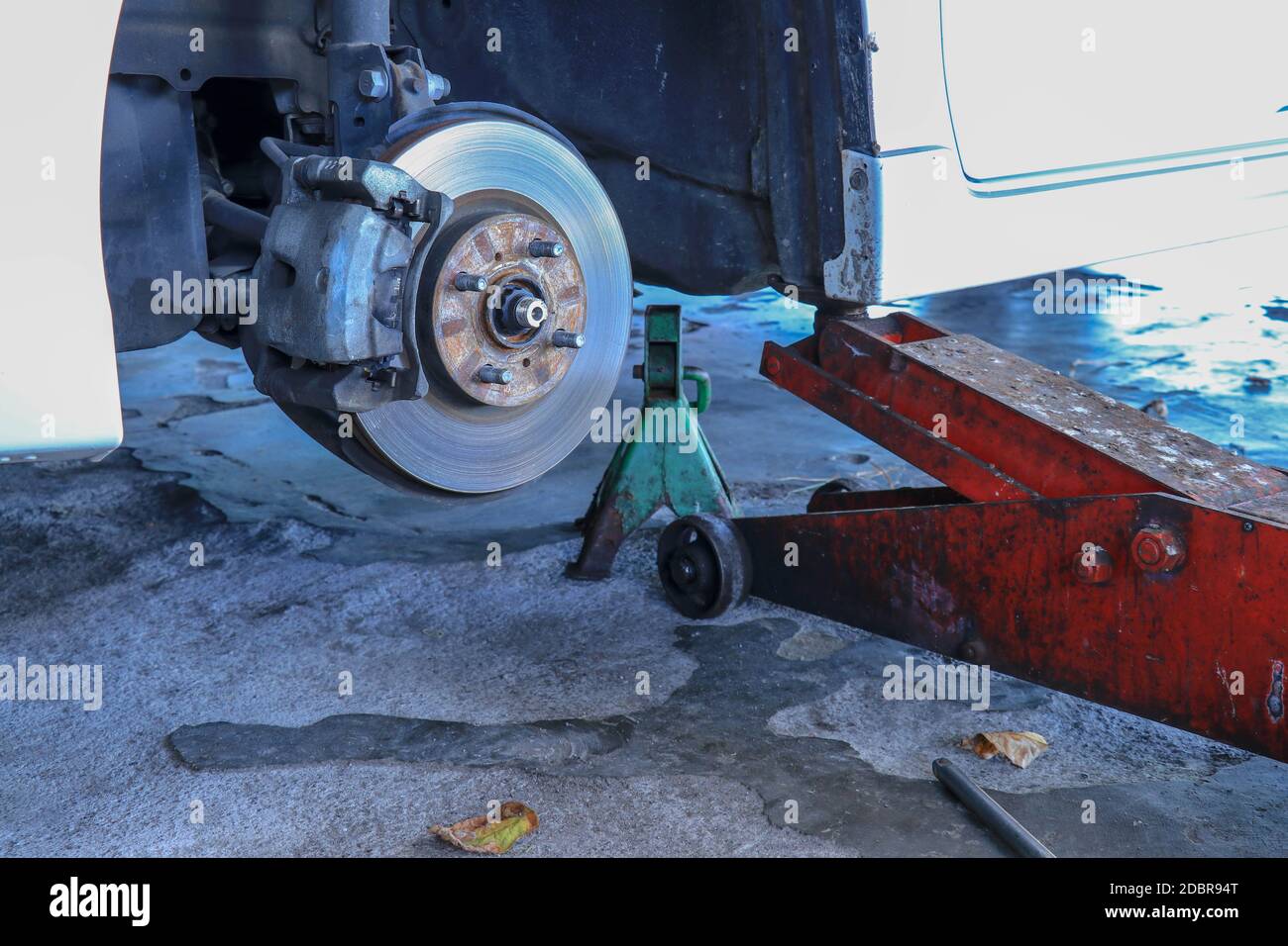 Front disc brake on car in process of new tire replacement. The rim is ...