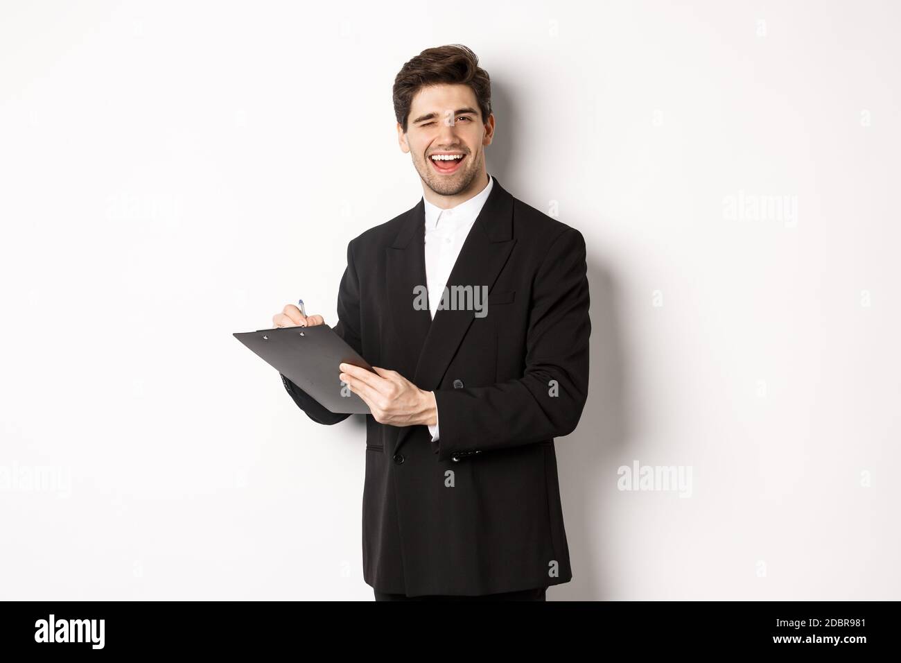 Image of handsome, successful boss in black suit, winking and smiling ...