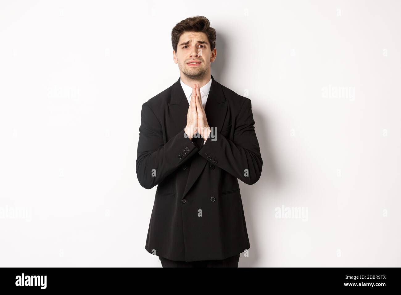 Image of handsome businessman in suit need help, begging you, holding ...