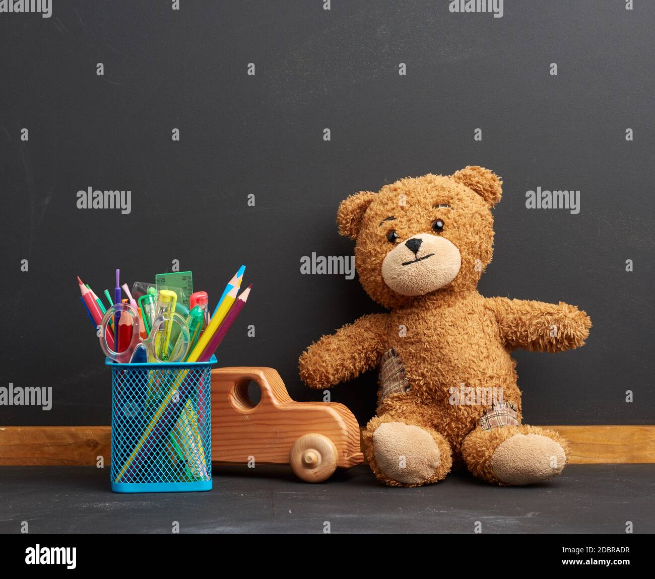 stationery and brown teddy bear sitting on the background of an empty ...