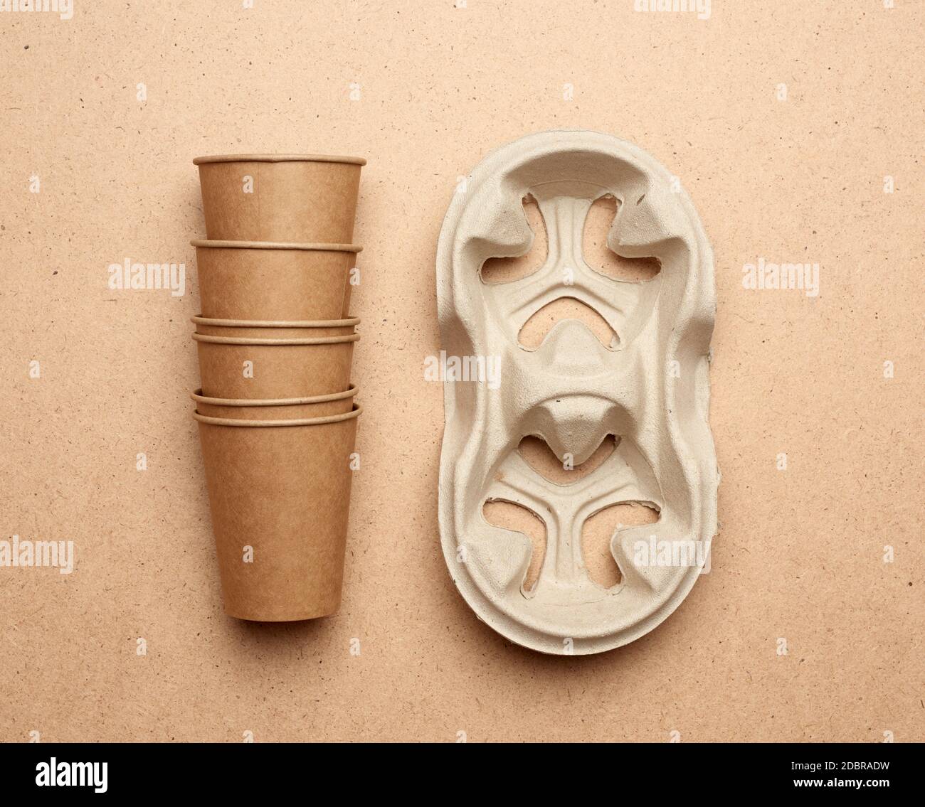 disposable brown paper craft cups and recycled paper holders on a brown ...