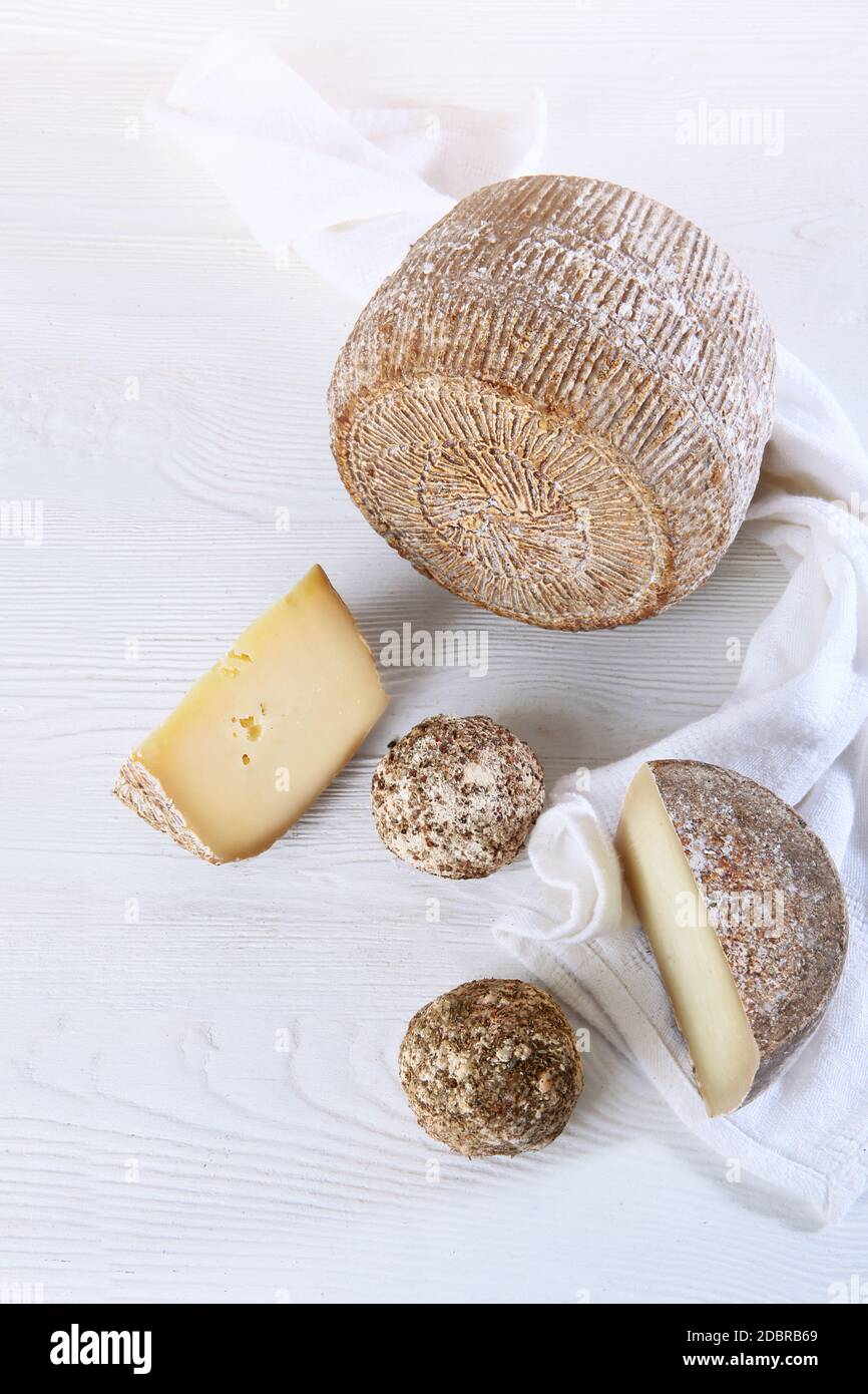 Assorted hard cheeses on a white background. Vertical photo. Copy space ...