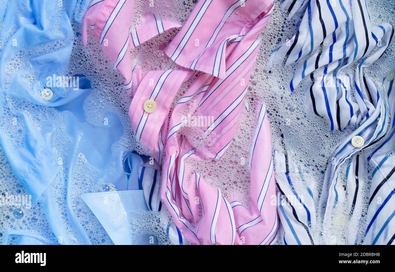 Top view of color clothes soak in powder detergent water dissolution ...