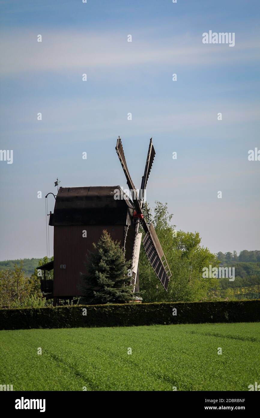 View of a well-preserved old post mill Stock Photo - Alamy