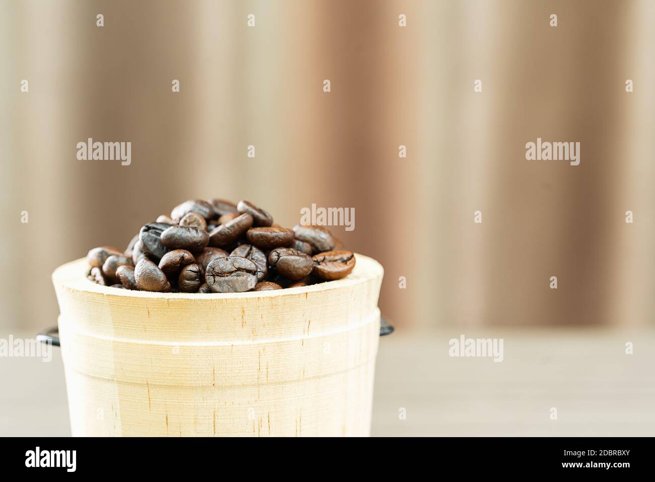 Coffee beans in a wood bucket close up Stock Photo - Alamy