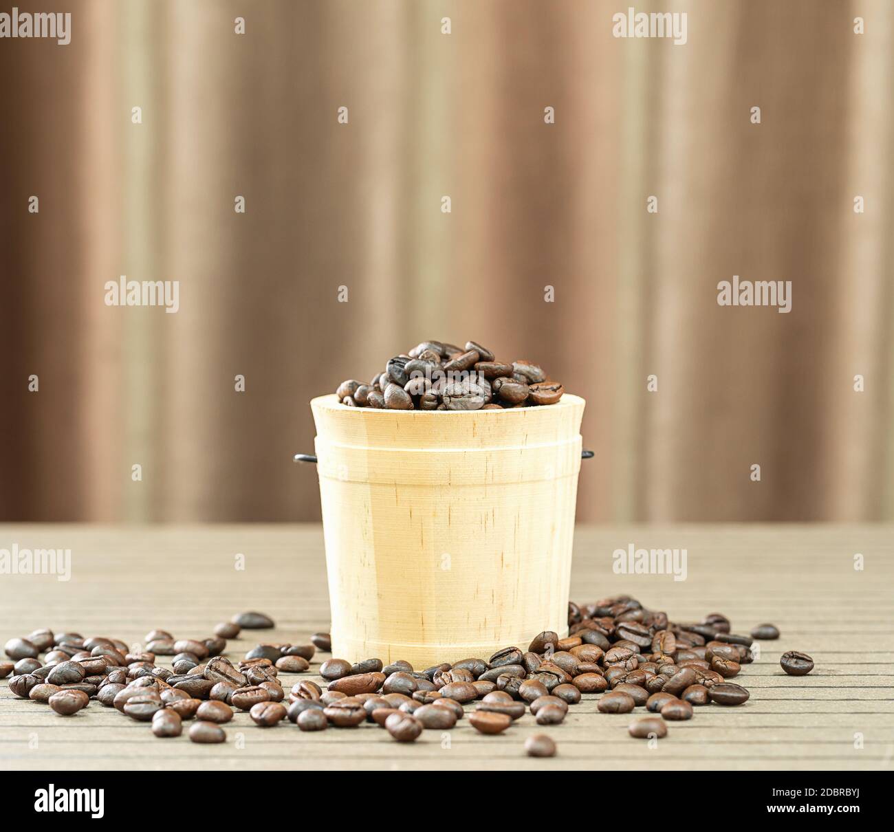 Coffee beans in wood bucket on wooden floor close up Stock Photo - Alamy