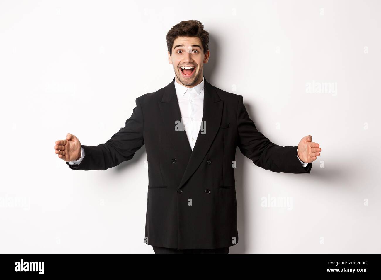 Portrait of excited handsome man in suit, shaping big object on copy ...
