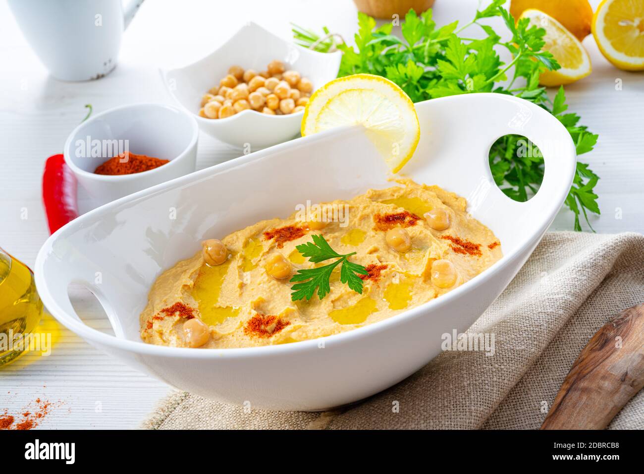 hummus paste with lemon and chilli on white background Stock Photo - Alamy