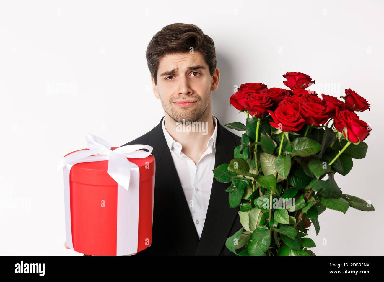 Sad guy holding bouquet flowers hi-res stock photography and images - Alamy