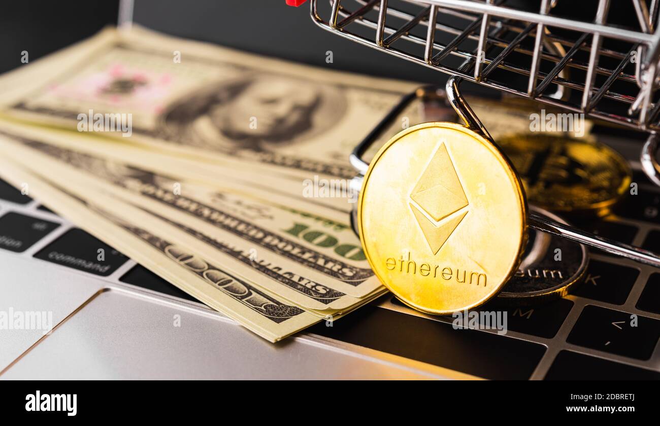 Shopping cart with golden ether coins or Ethereum network exchange and ...