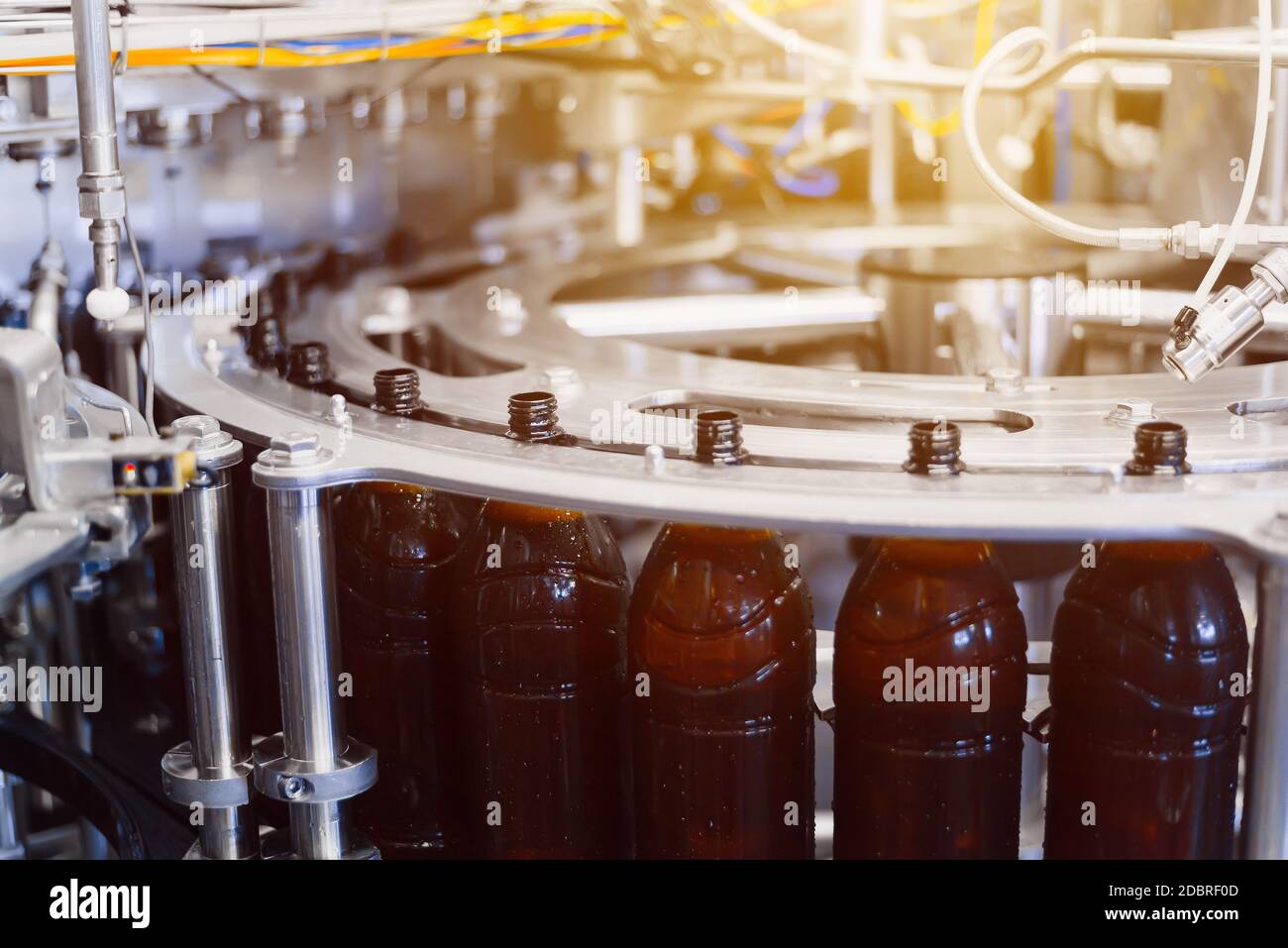 Beer filling line close-up. Beer filling process in an automatic line ...