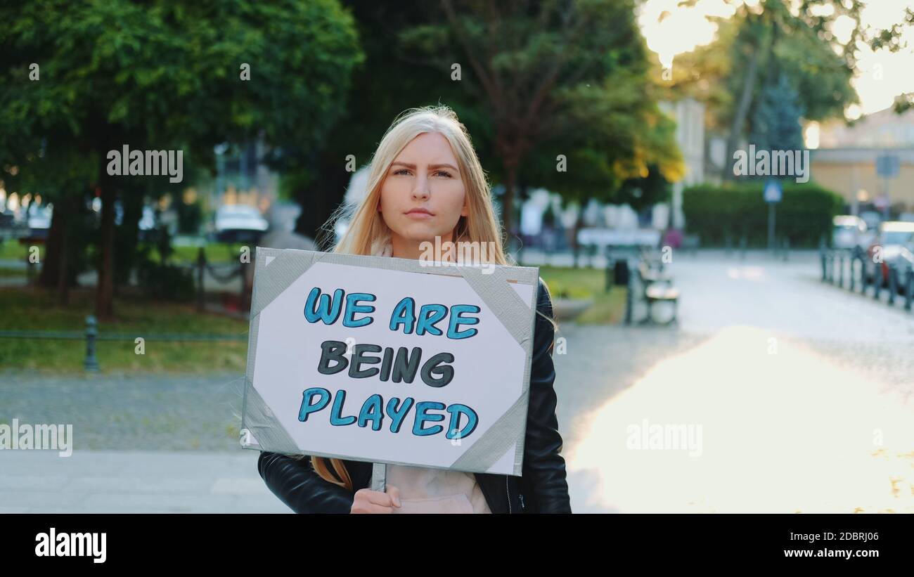 Pretty girl protesting against authorities that playing human lives ...