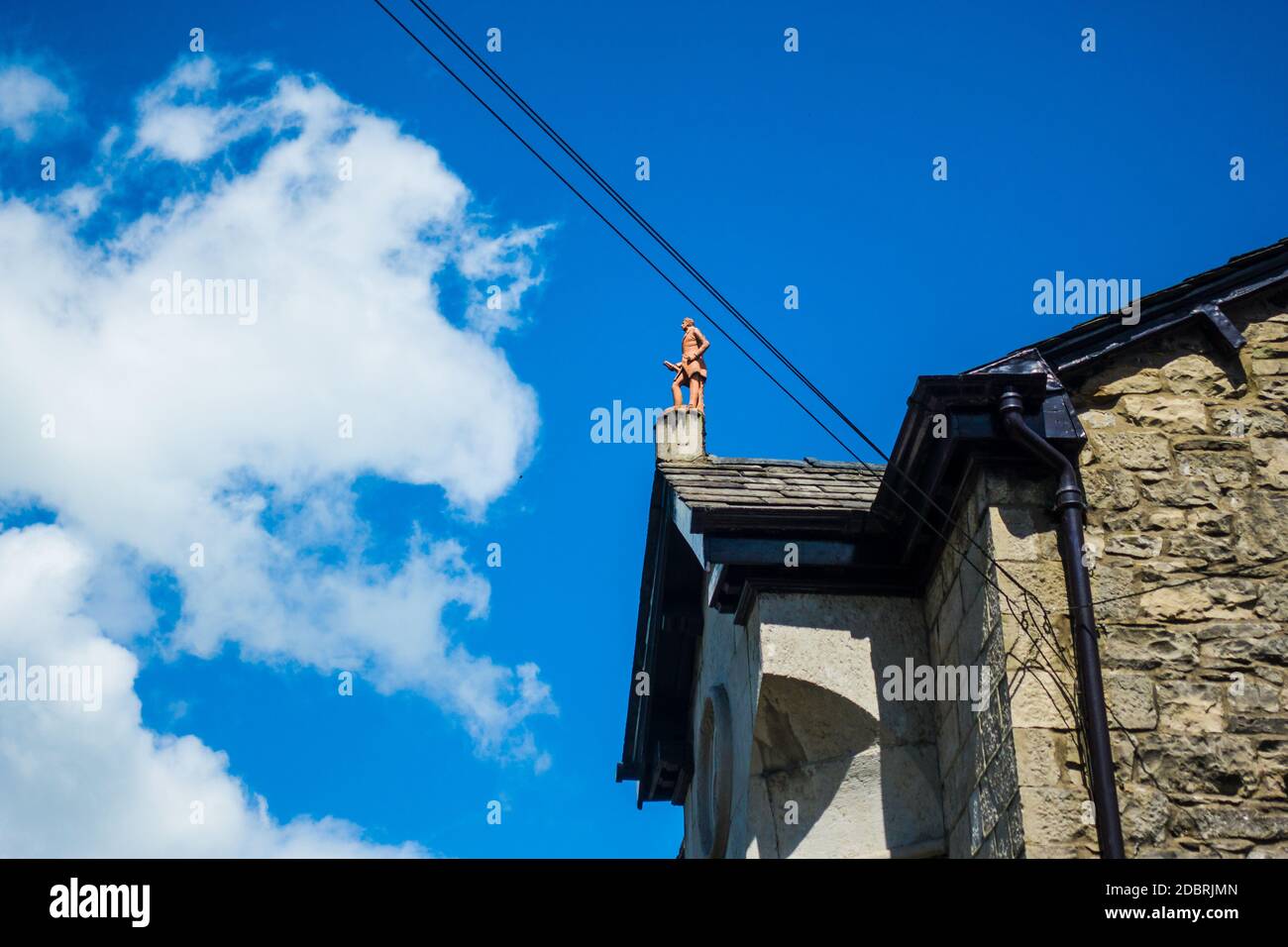 roof top statue of a man on Beast Banks Kendal Cumbria Stock Photo - Alamy