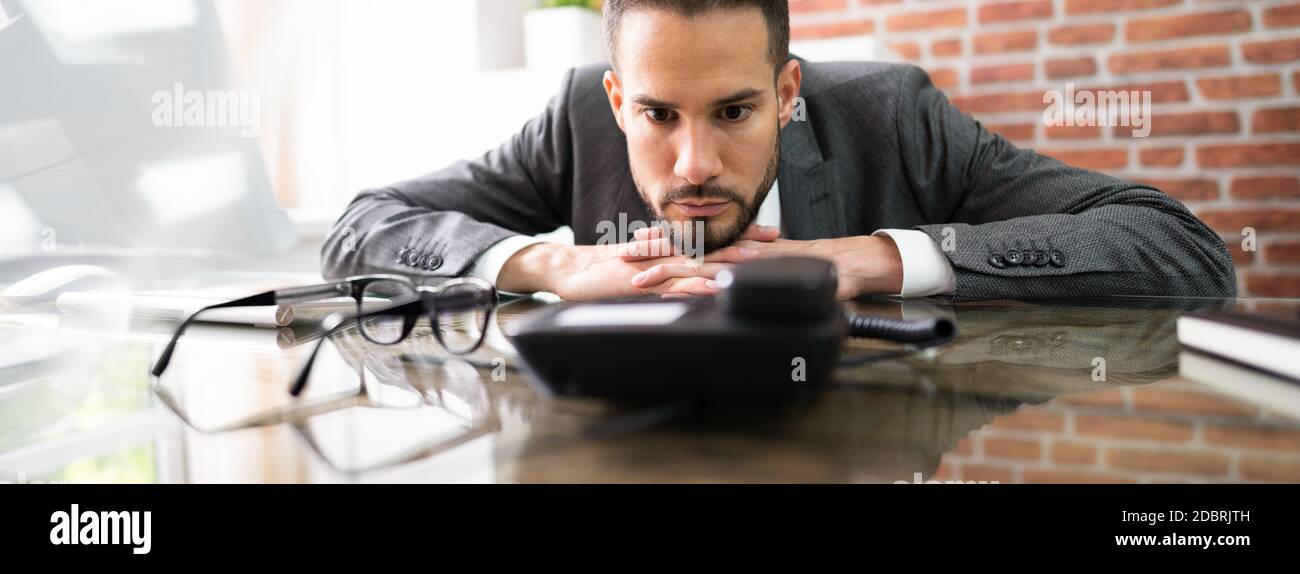 Waiting Landline Telephone Call At Office Desk Stock Photo - Alamy