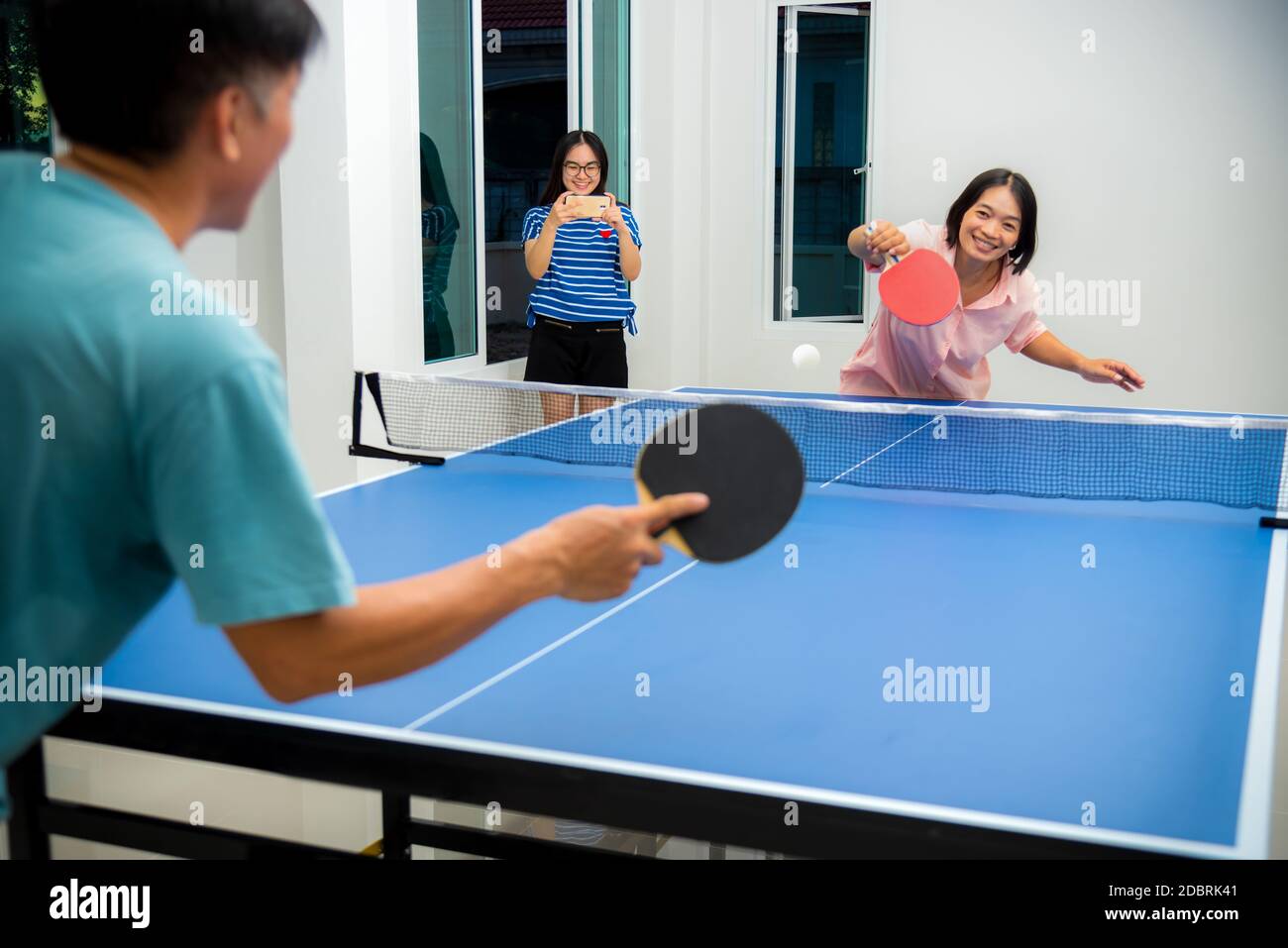 Couple fun playing table tennis or Ping pong indoor together leisure ...