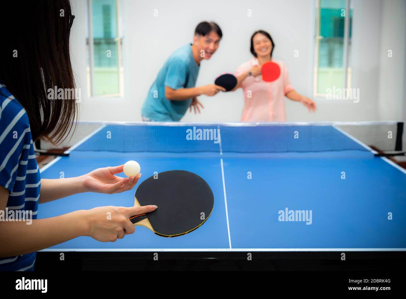 Couple fun playing table tennis or Ping pong indoor together leisure ...