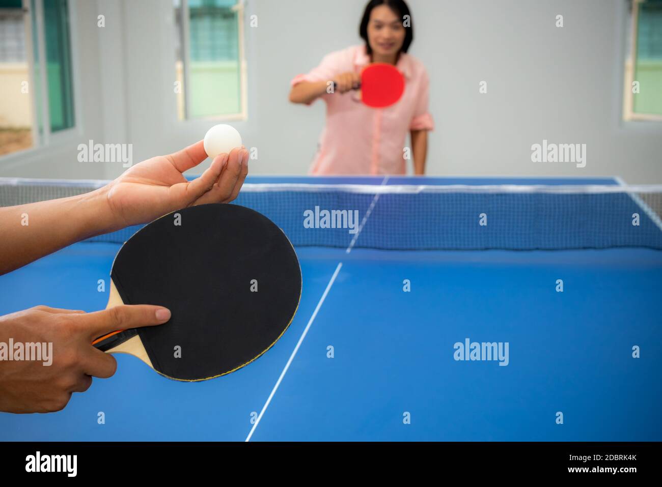 Adult Asian woman are waiting to start playing table tennis or Ping ...