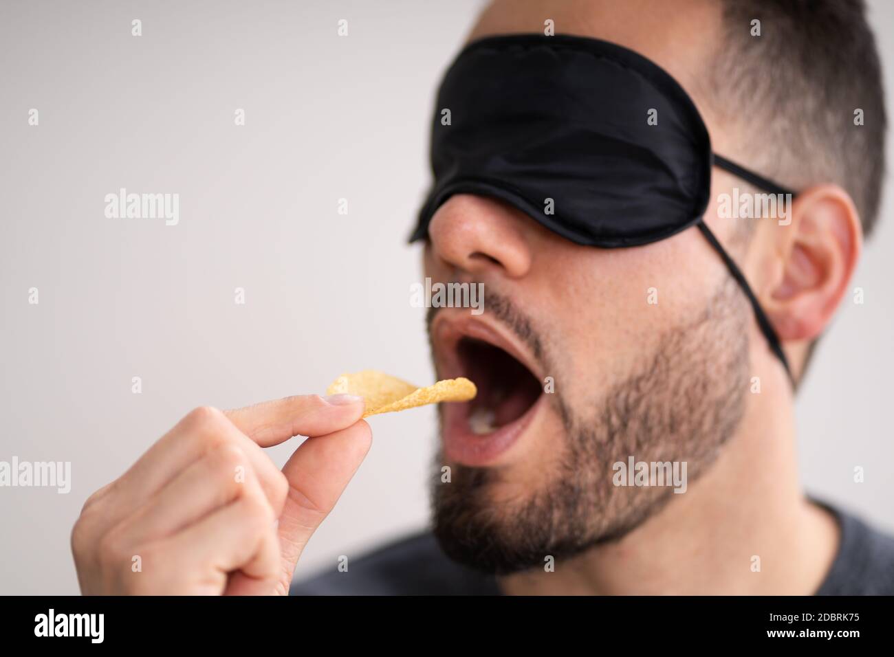 Blind Taste. Blindfolded Food Test. Man Face Stock Photo - Alamy