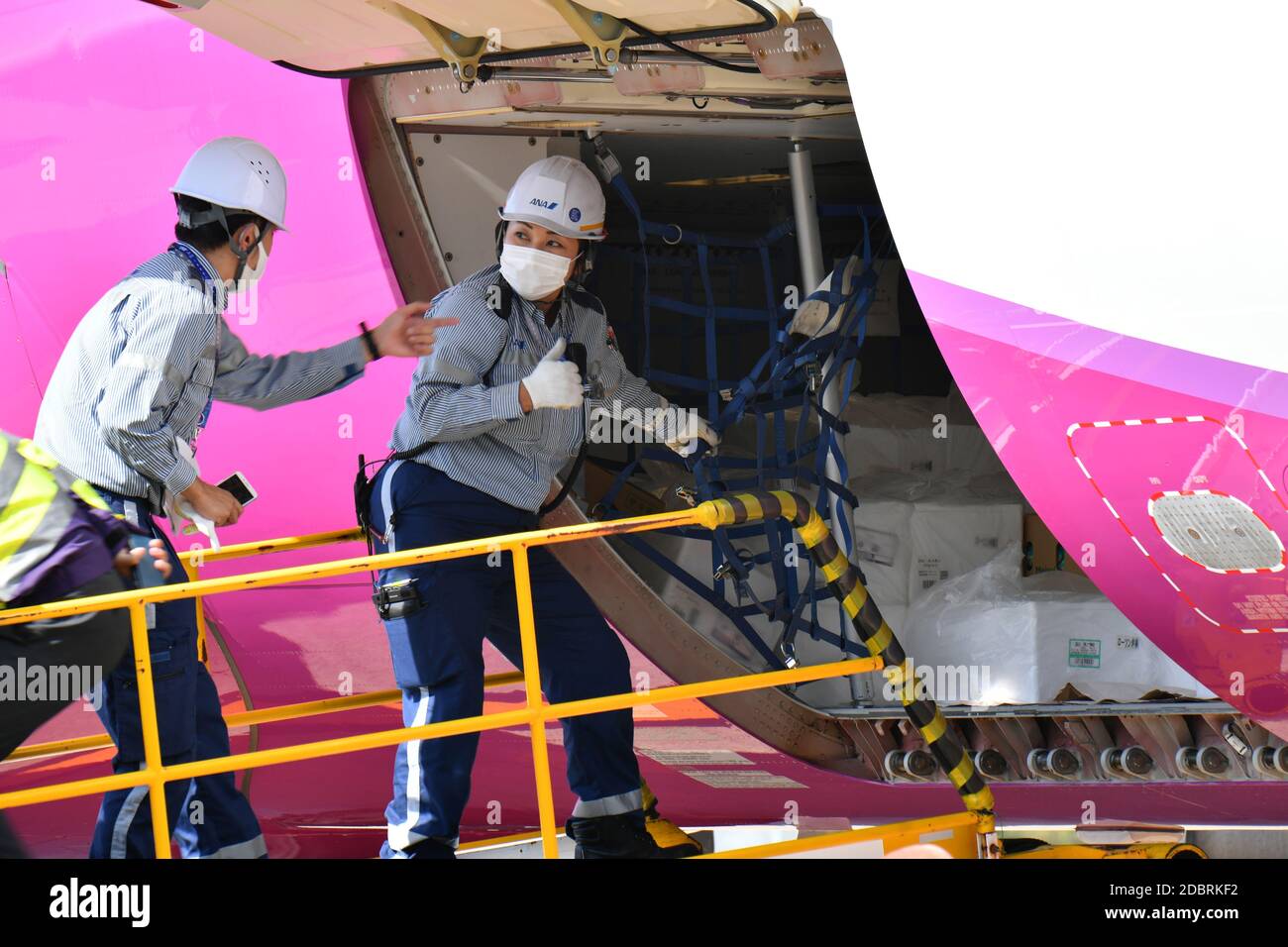 Ground handling staff loading ANAs cargo onto a Peach's A320 at Fukuoka ...