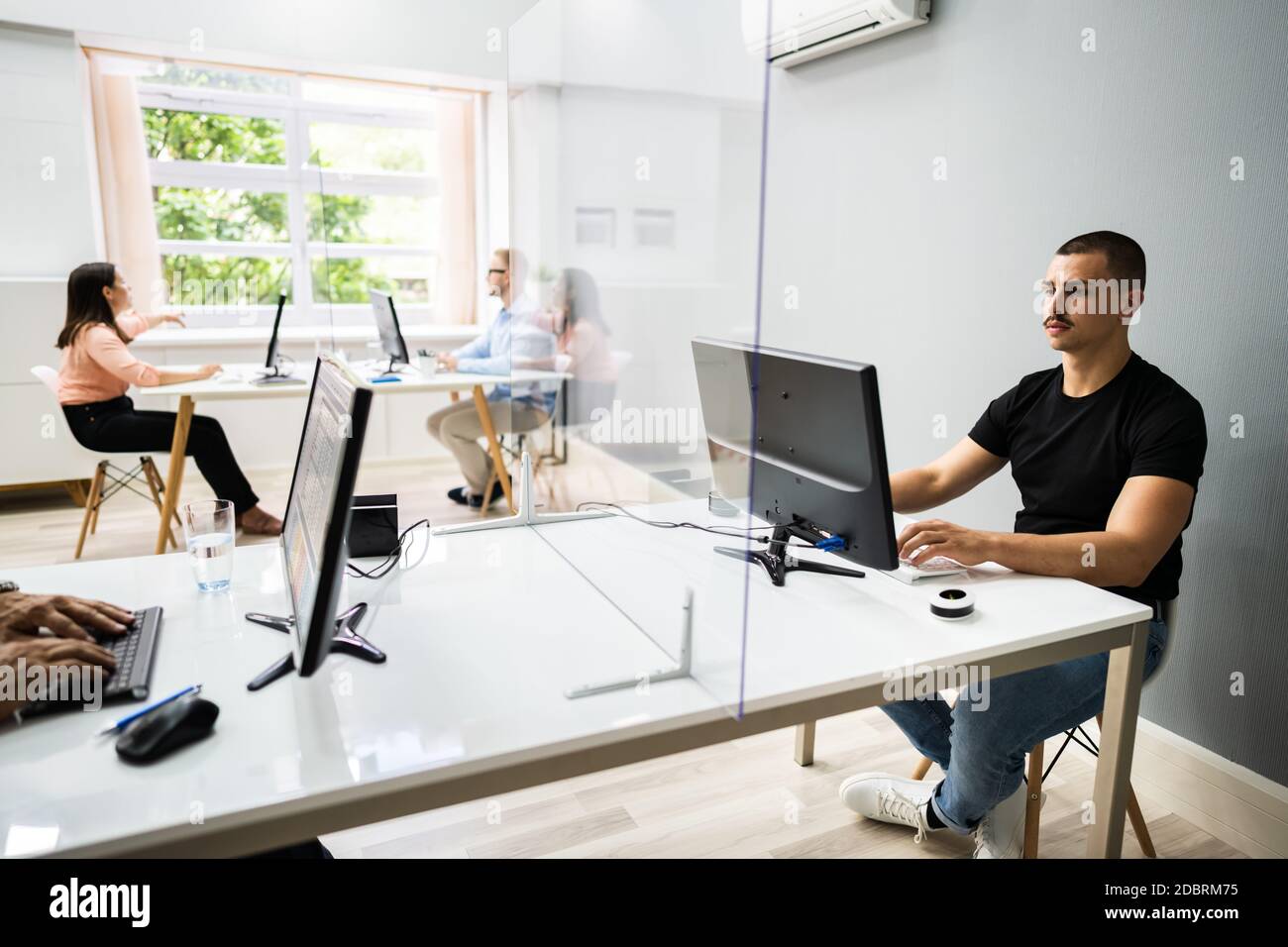 Business Employee Social Distancing Using Sneeze Guards In Office Stock ...
