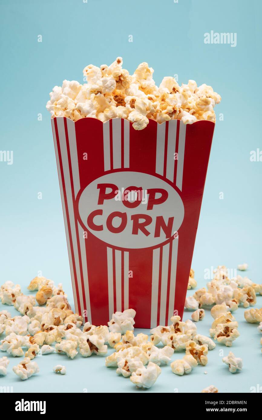 Large paper cup filled with salted Pocorn on bright blue Background ...