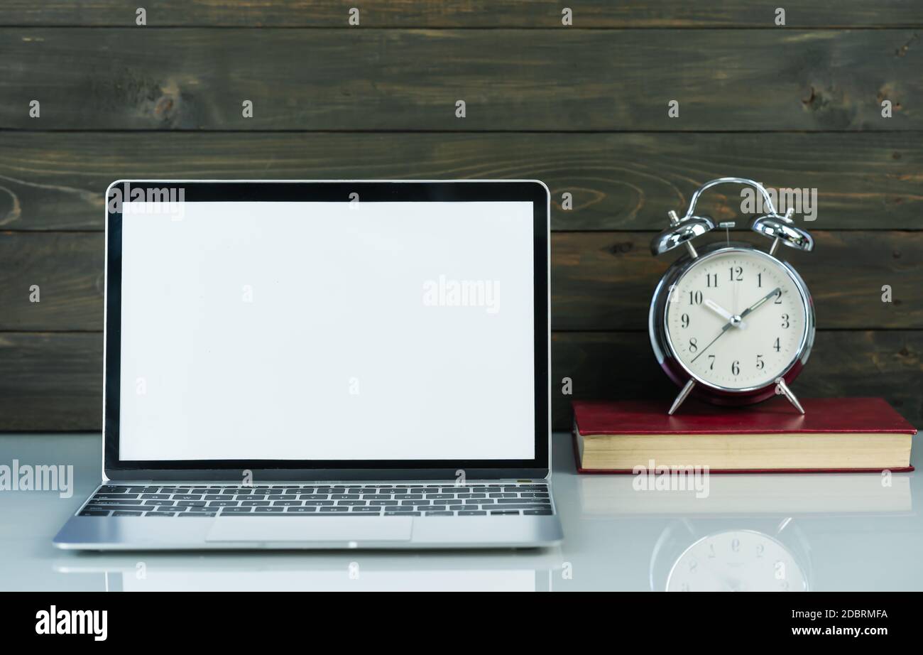 Front view of Laptop mockup and alarm clock with wood background on the ...
