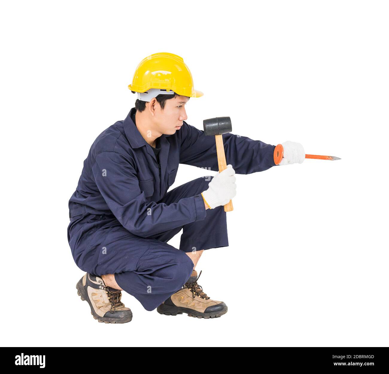 Young man in uniform sit and holding hammer was nailed to a cold chisel ...