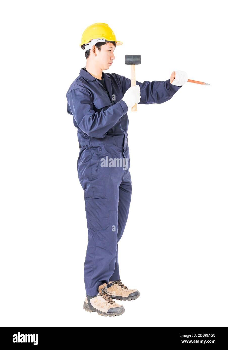 Young man in uniform sit and holding hammer was nailed to a cold chisel ...