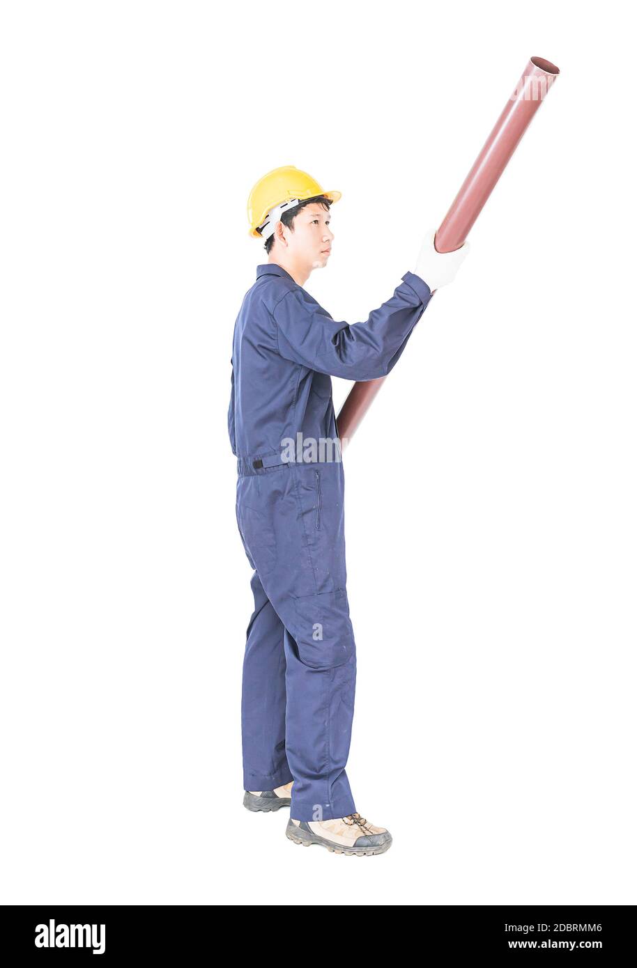 Young plumber in uniform holding pvc pipe isolated on white background ...