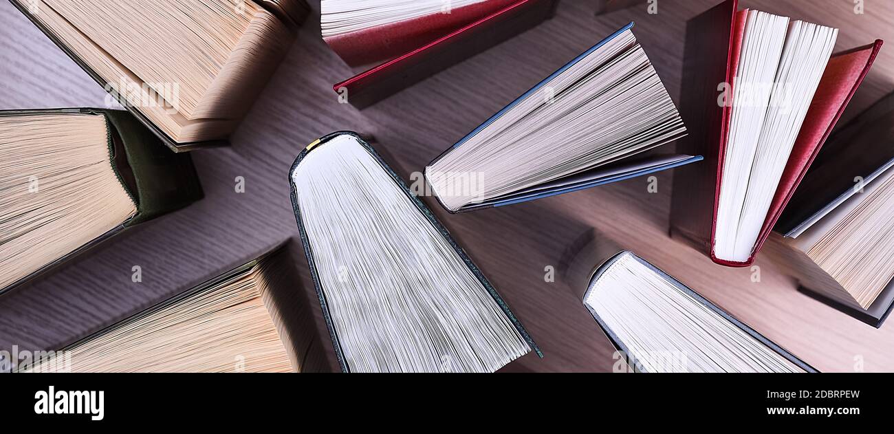 Books on the table, top view. In books, the sheets are spread out in ...
