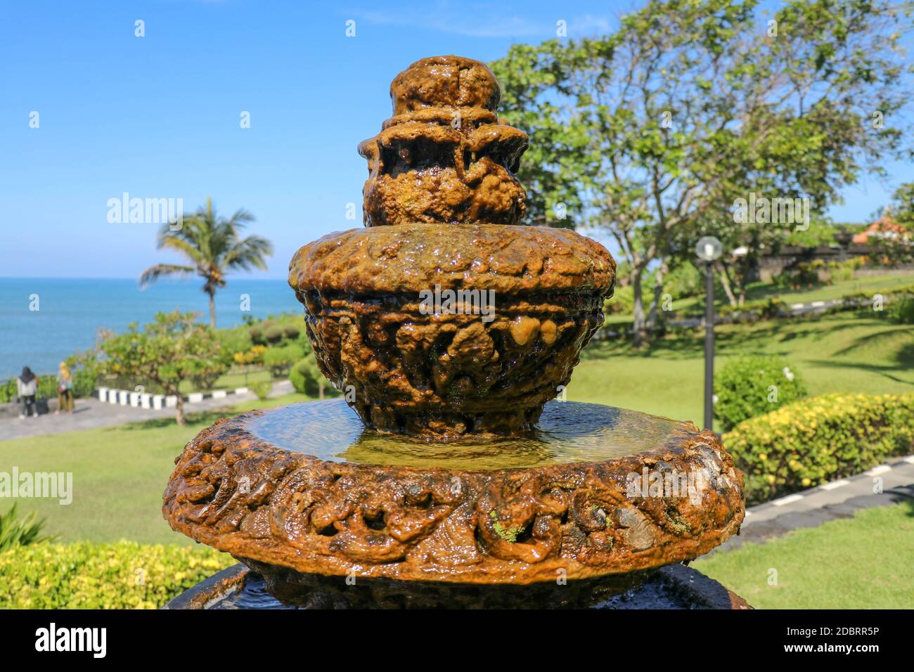 Peaceful scenery with fountain. Park near the Hindu Temple Tanah Lot ...