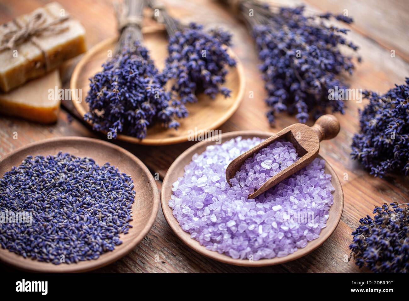 Lavender flowers and coloured bathing salt in wooden plate Stock Photo ...