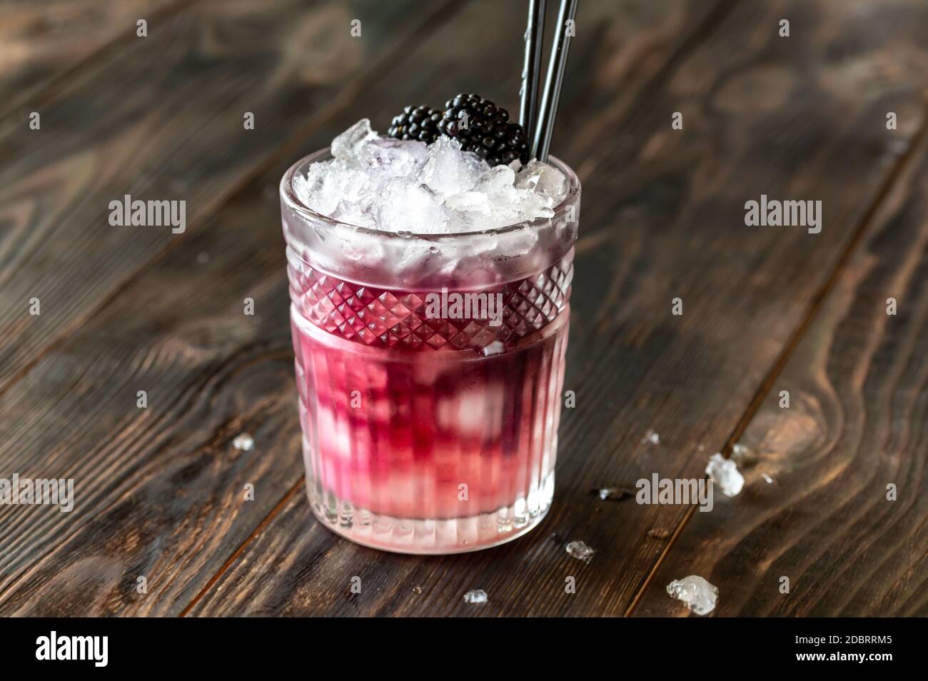 Glass of Bramble cocktail made of gin, lemon juice, sugar sypup and ...