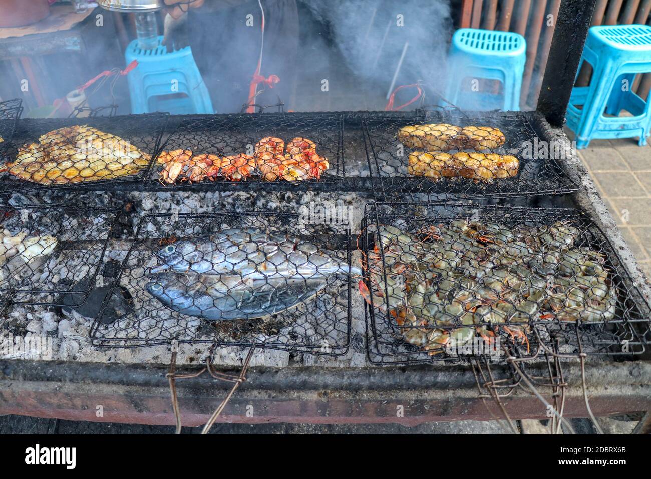 Fish barbecue. Cooking BBQ seafood on fire. Grill with burning coals ...