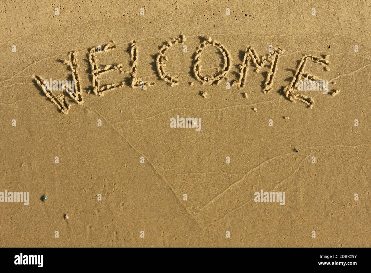 Word welcome written on the sand, as the background Stock Photo - Alamy