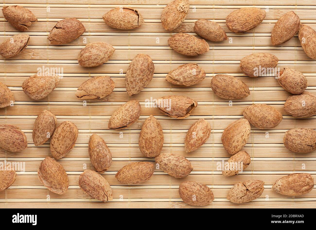 almond lying on a bamboo mat, can be used as background Stock Photo - Alamy