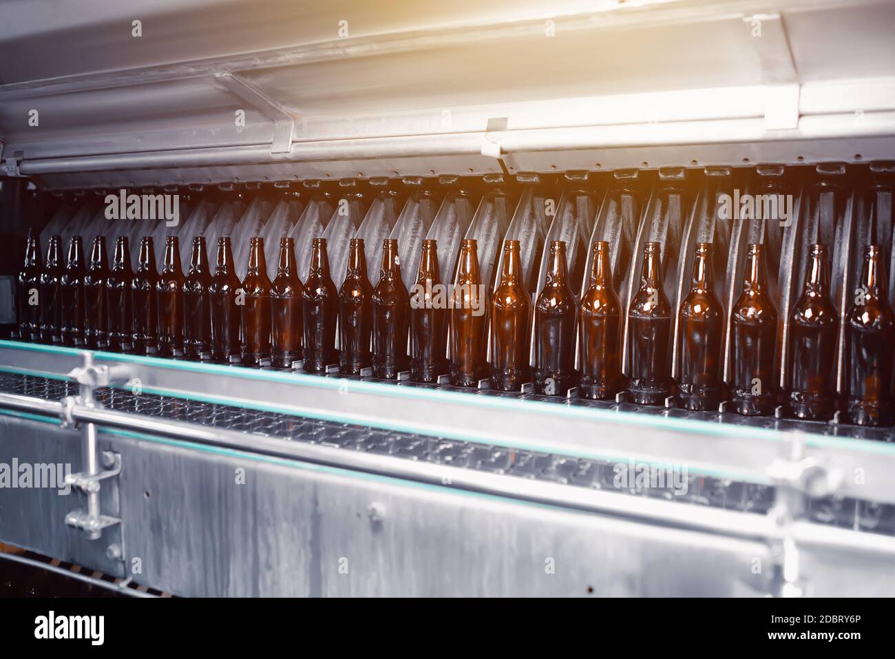 Glass brown beer bottles in industrial bottle washer Stock Photo - Alamy