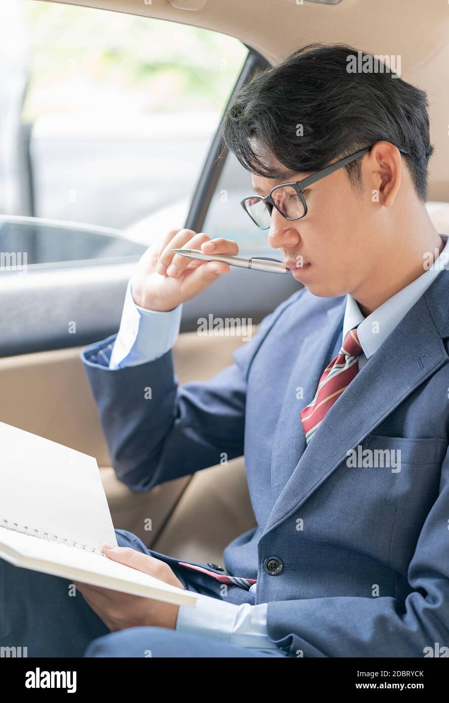 Young asian business men portrait in suit working in the backseat of a ...
