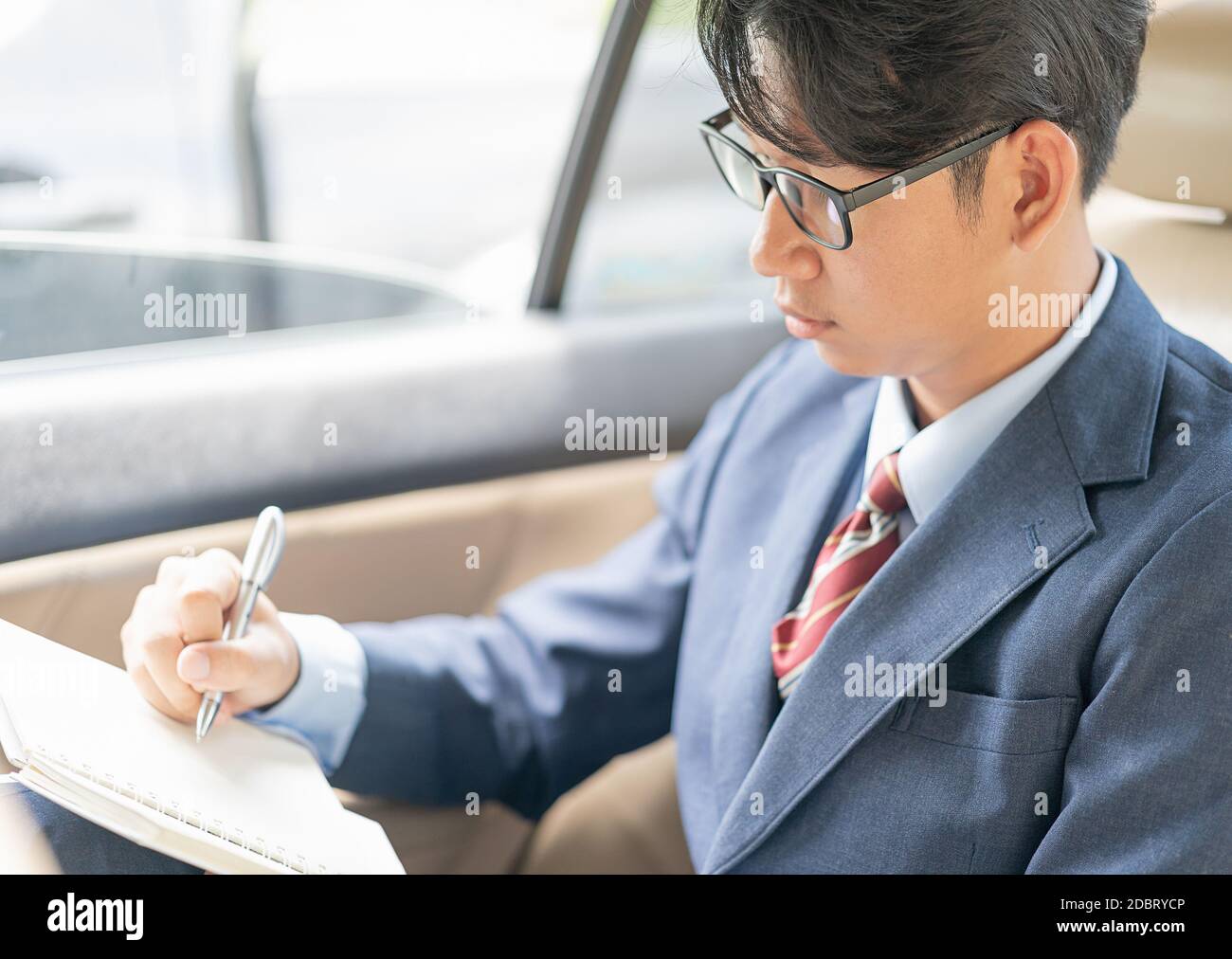 Young asian business men portrait in suit working in the backseat of a ...